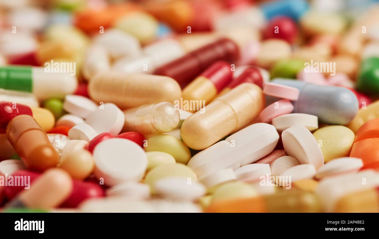 A lot of colorful tablets and medicines drugs in a heap Stock Photo - Alamy