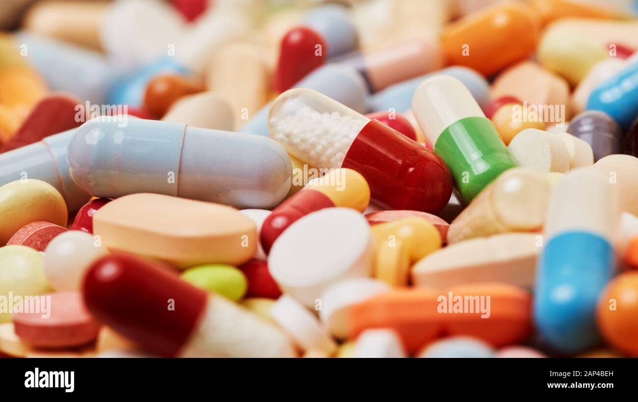 Many colorful tablets and pills as medication concept background Stock ...