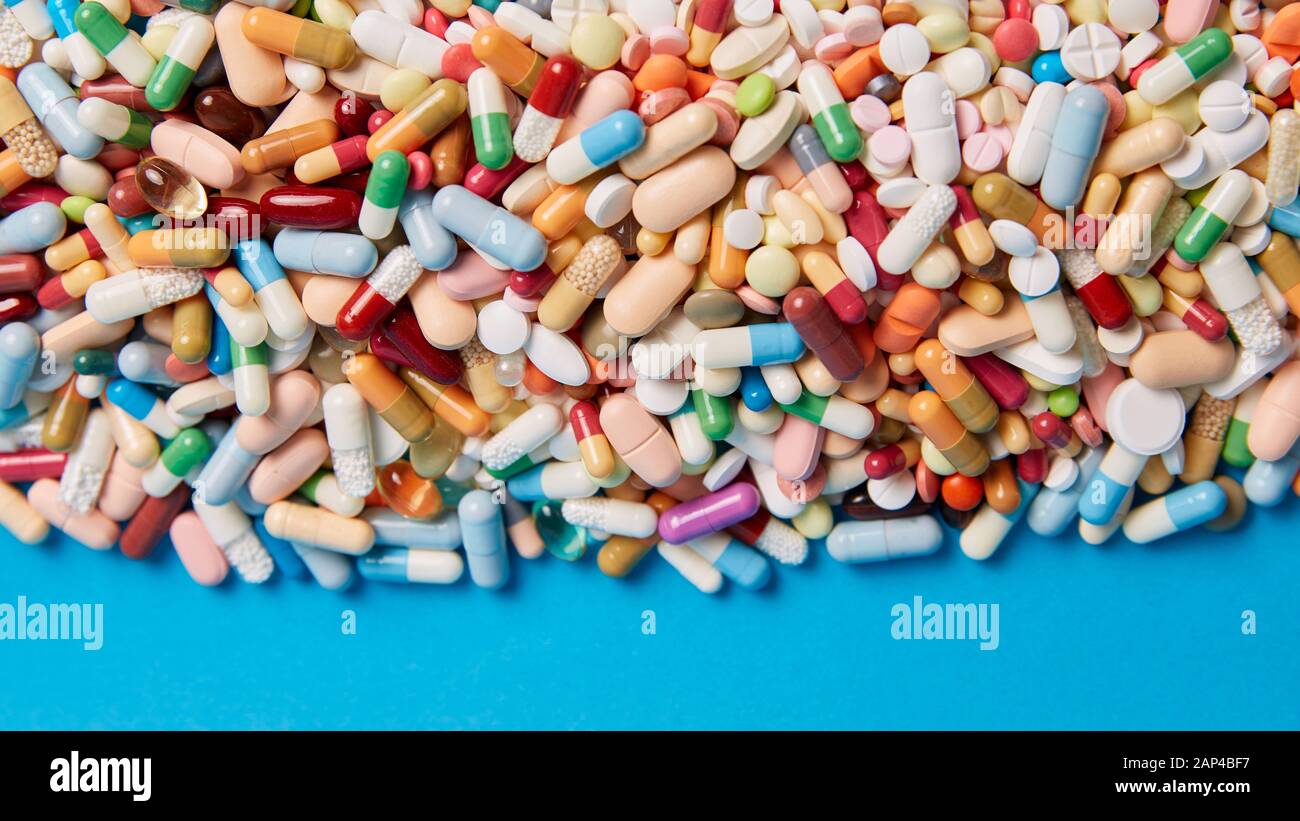 Medicine background with colorful medication on a blue background Stock ...