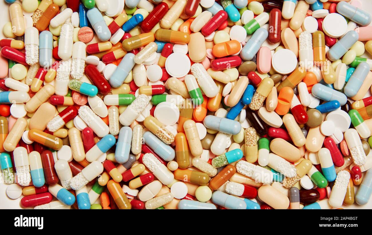 medicines drugs background with lots of colorful capsule and pills ...