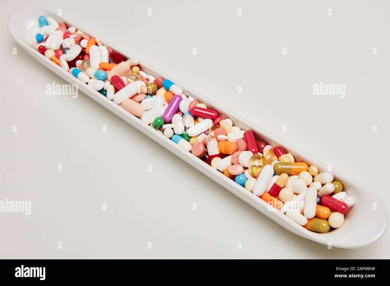 Bowl with lots of colorful medicines drugs and tablets and pills Stock ...