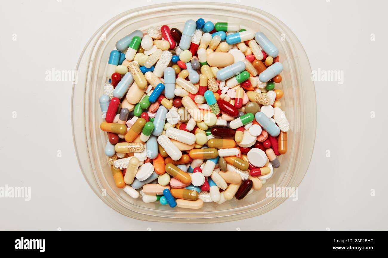 Lots of colorful medicines drugs from above in an open plastic can ...