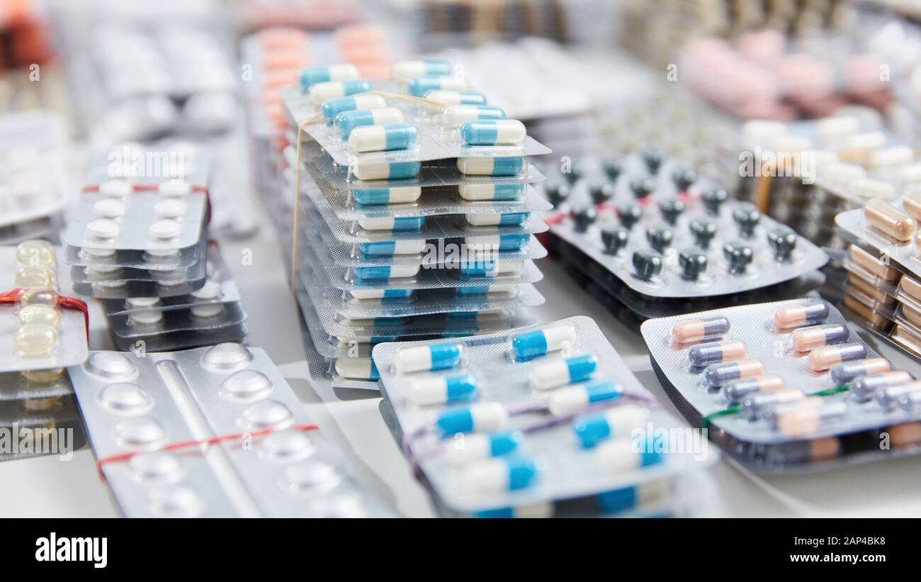 Lots of assorted pills and tablets and medication on piles in a ...