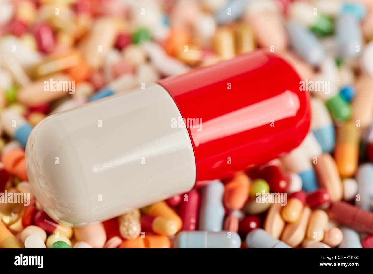 Big pill and lots of colorful medicines drugs are in a heap Stock Photo ...