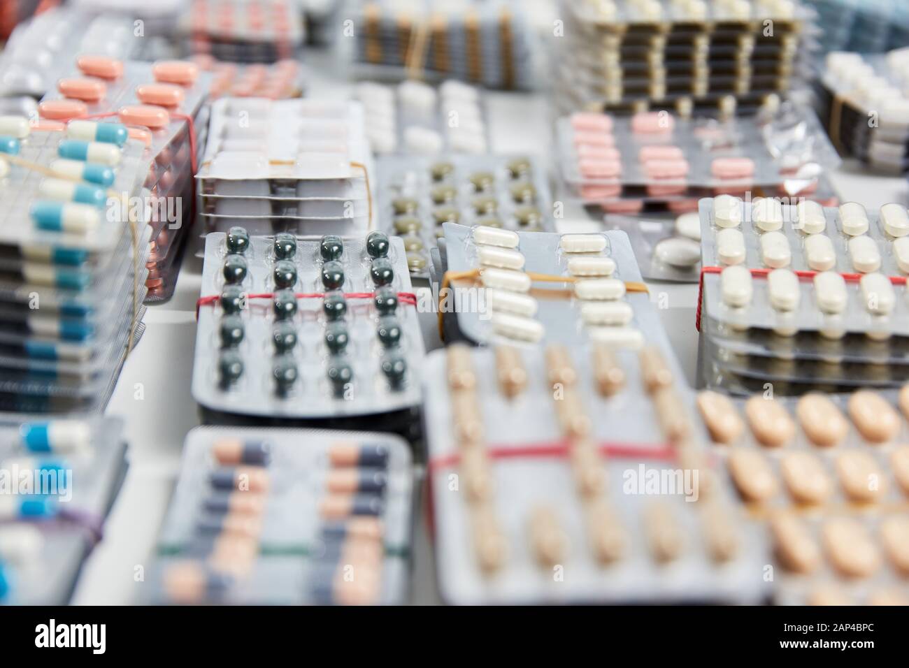 Many tablets and medicines drugs as medicines drugs sorted on stacks in ...