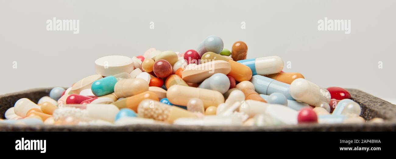 Pile of colorful medicines drugs as a header background with copy space ...