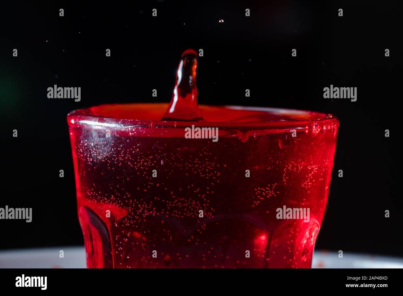 drops of red liquid in glass beaker Stock Photo - Alamy