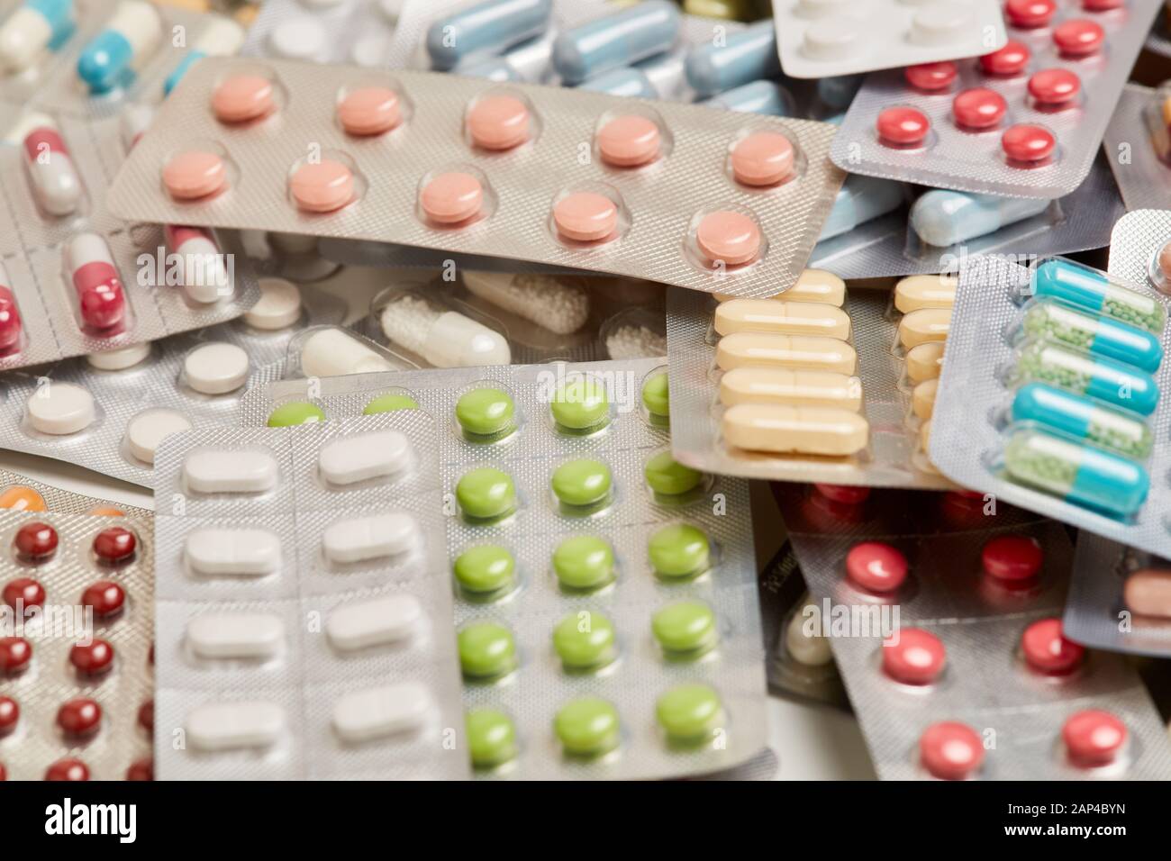 Many colorful medicines drugs in blister packs in a pile as a ...