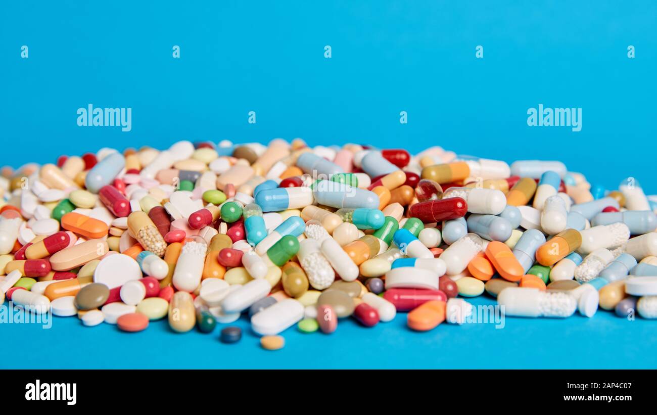 Blue medication and tablets background with copy space Stock Photo - Alamy