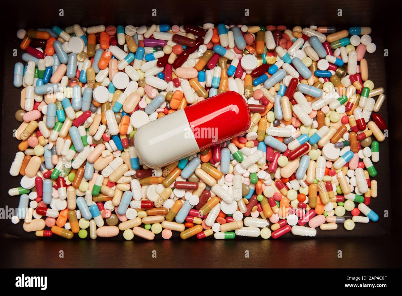 Large pill with colorful medication in a black box Stock Photo - Alamy