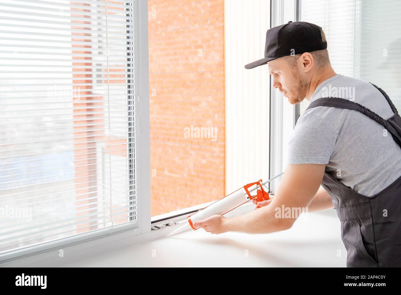 Construction worker use gun silicone tube for repairing and installing ...