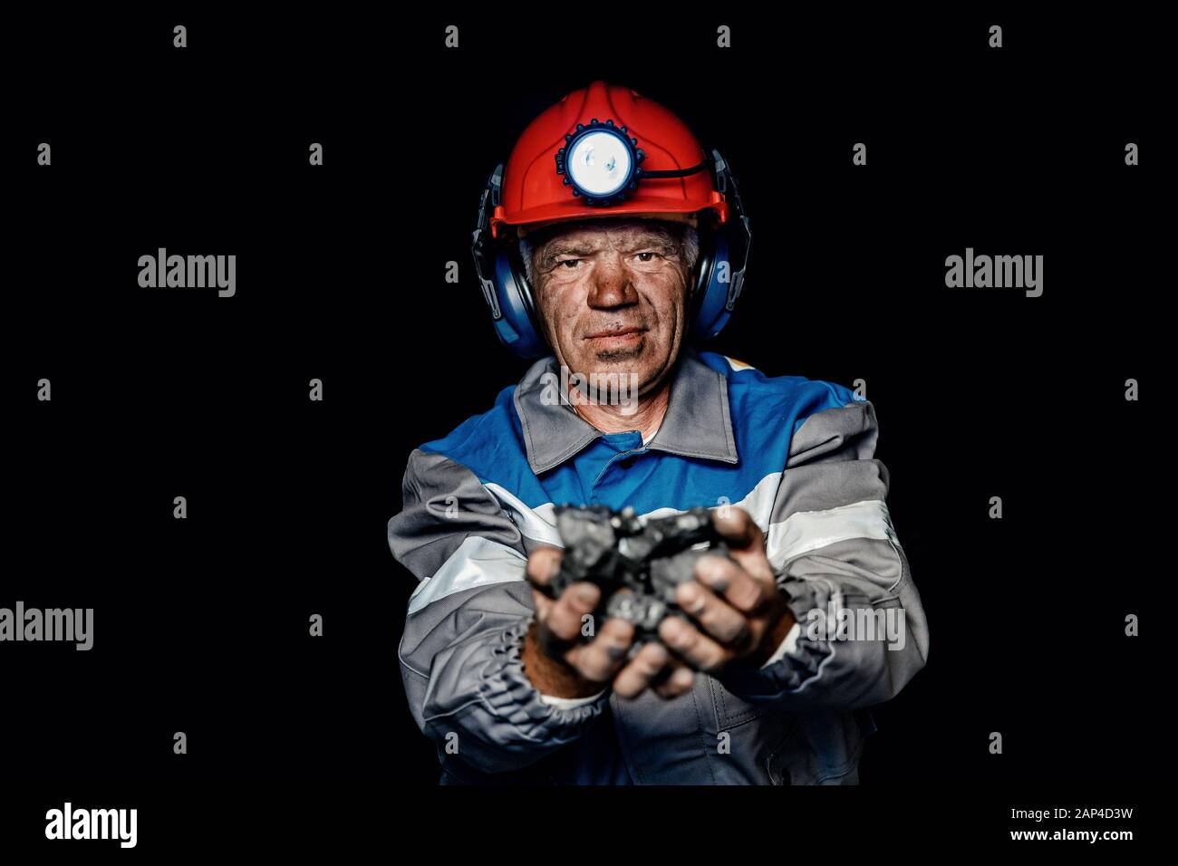 Portrait miner coal man in helmet with lantern in underground mine ...