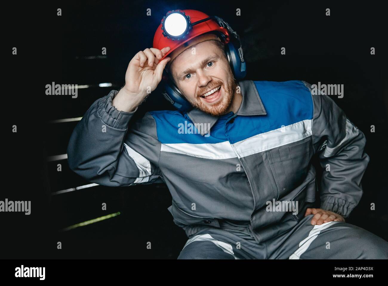 Portrait miner coal man in helmet with lantern in underground mine ...