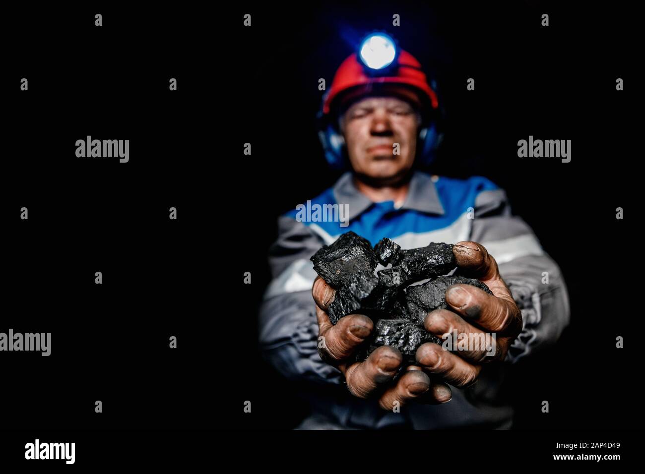 Miner man worker holds coal palm. Concept mining Stock Photo - Alamy