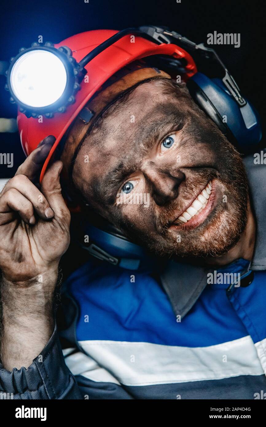Miner happy man smiling after working on coal mine. Concept industrial ...