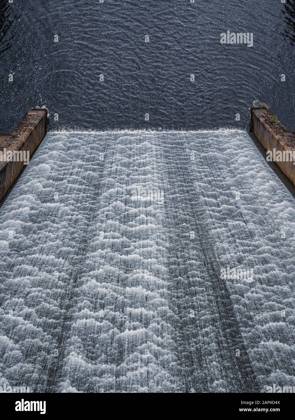 Water flowing down the dam of a reservoir Stock Photo - Alamy