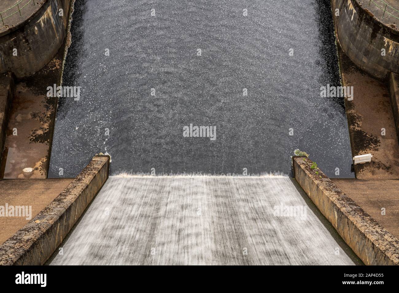 Water flowing down the dam of a reservoir Stock Photo - Alamy