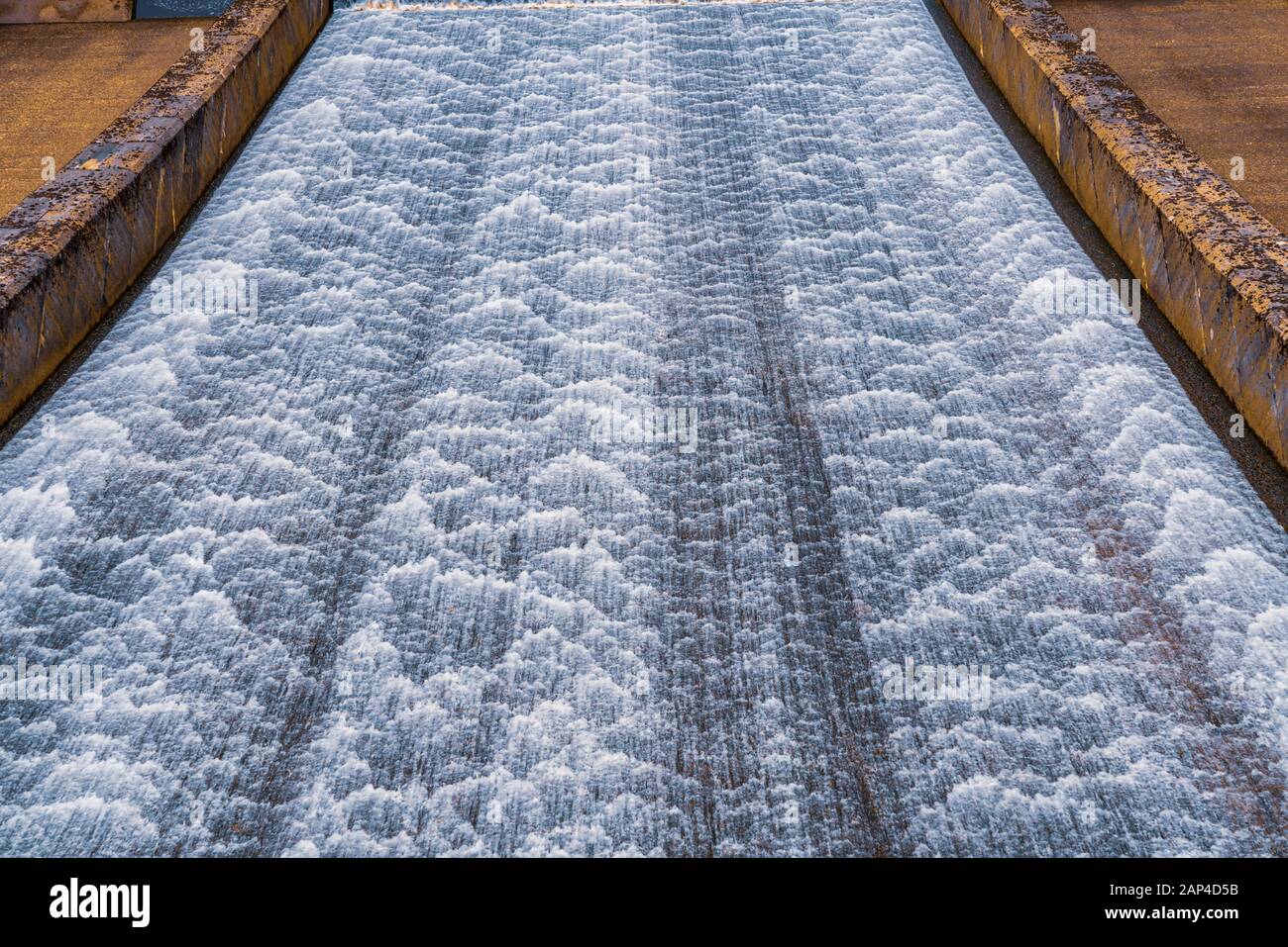 Water flowing down the dam of a reservoir Stock Photo - Alamy