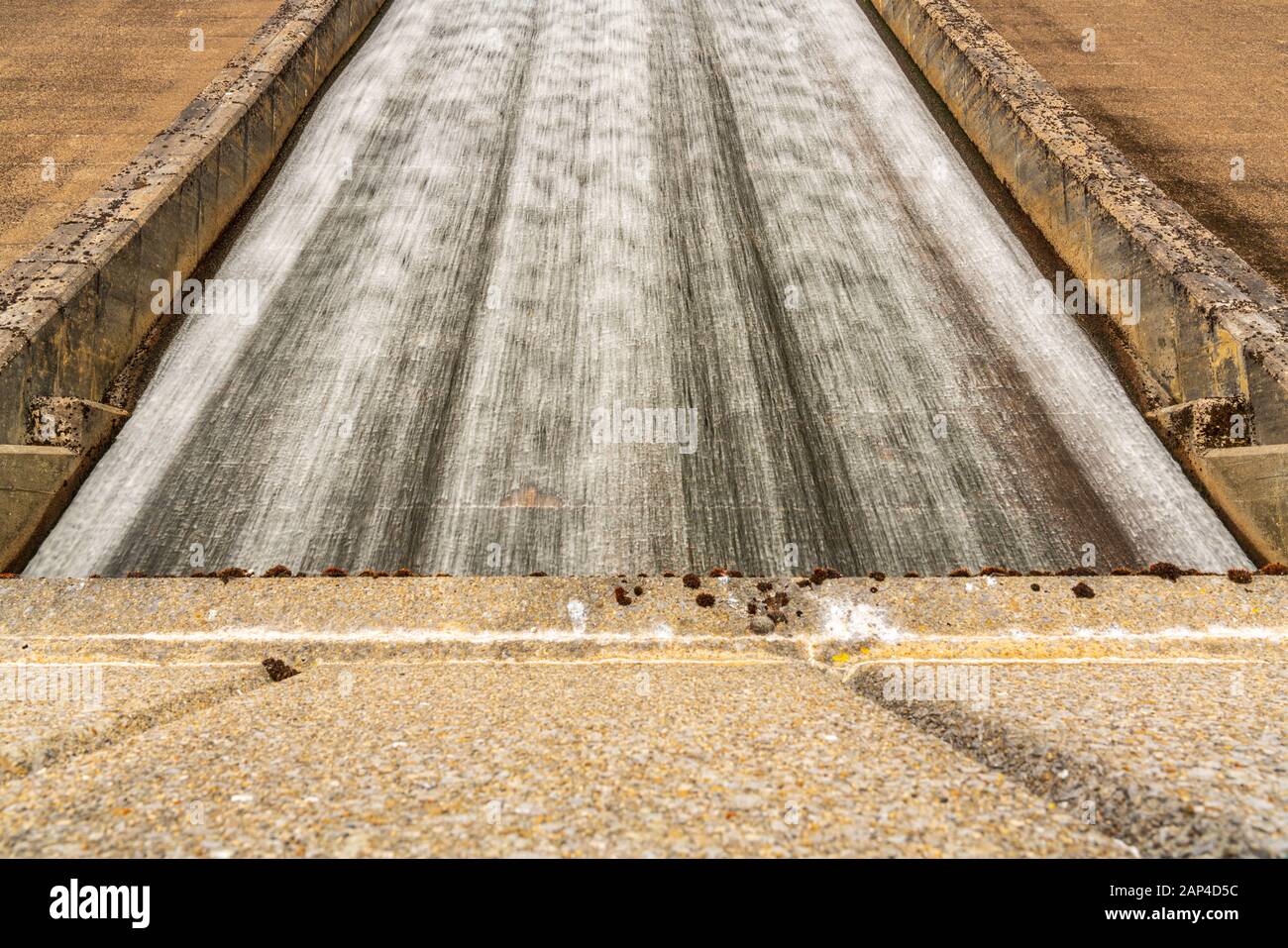 Water flowing down the dam of a reservoir Stock Photo - Alamy