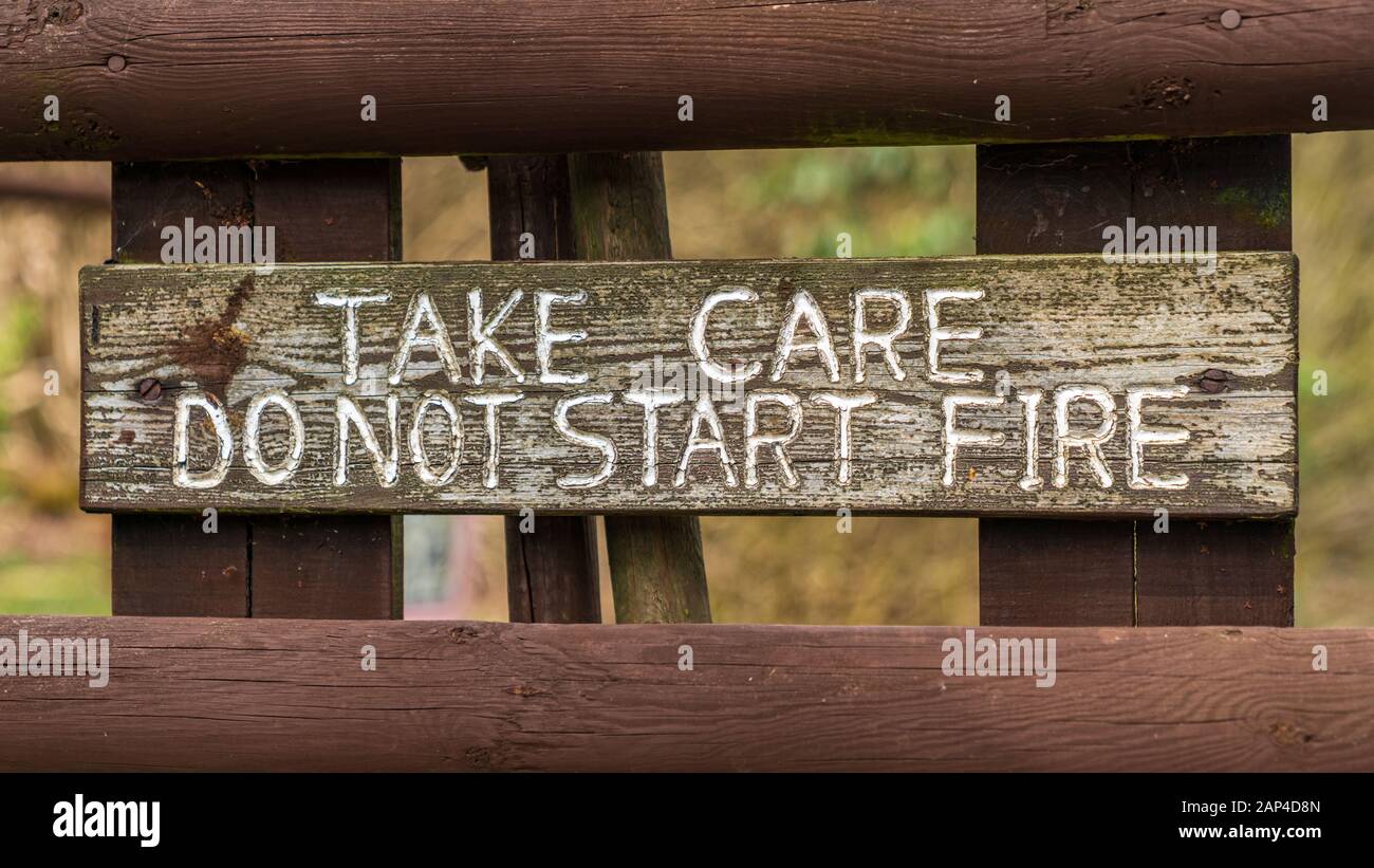 Sign: Take care do not start fire - with blurry background Stock Photo ...