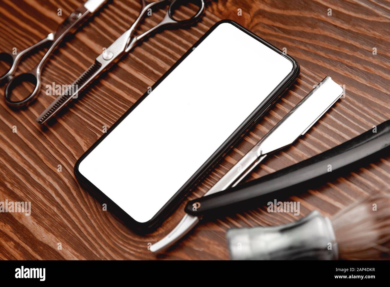 Hairdresser barber shop tools with mobile phone screen on old wooden ...