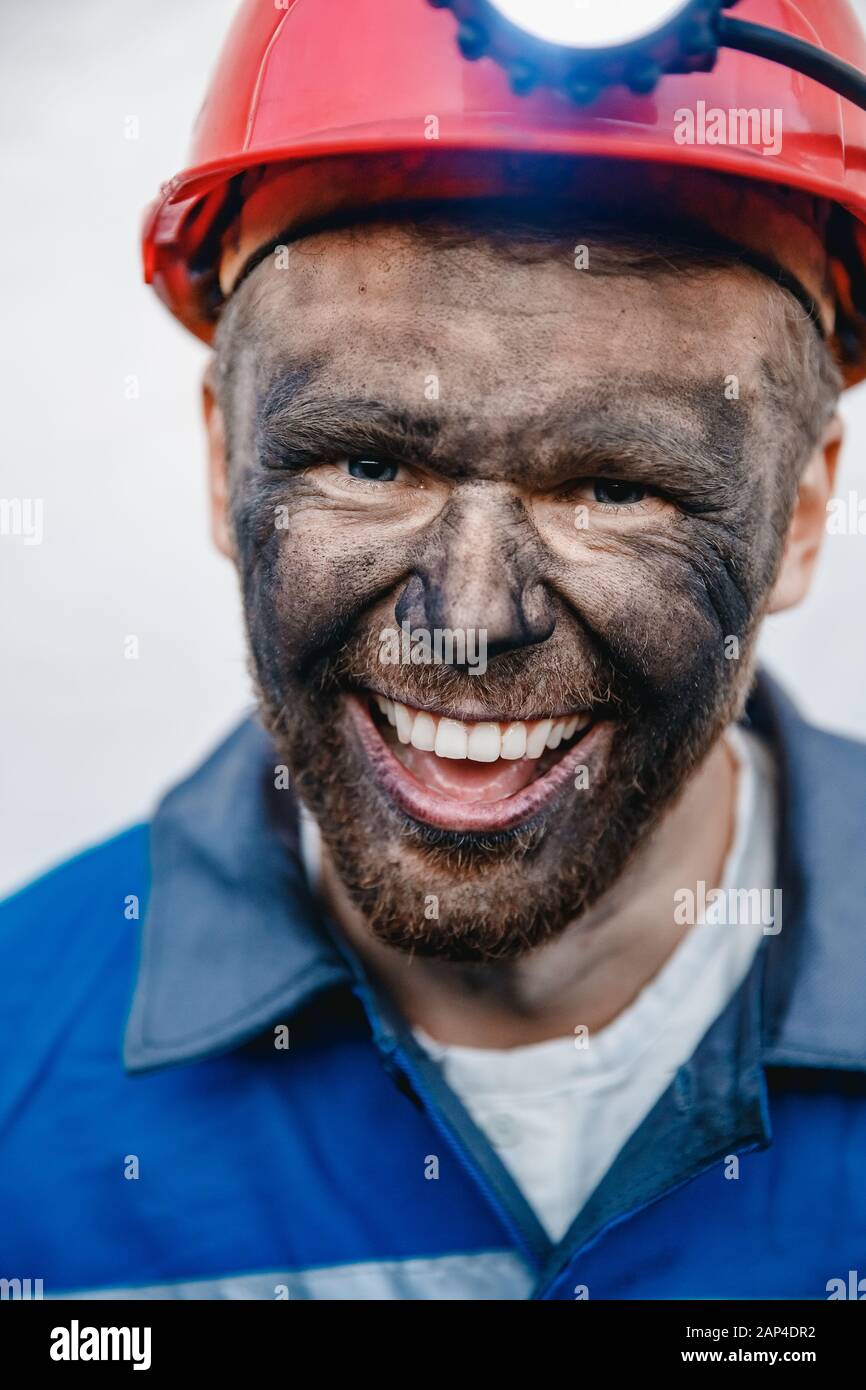 Miner happy man smiling after working on coal mine. Concept industrial ...