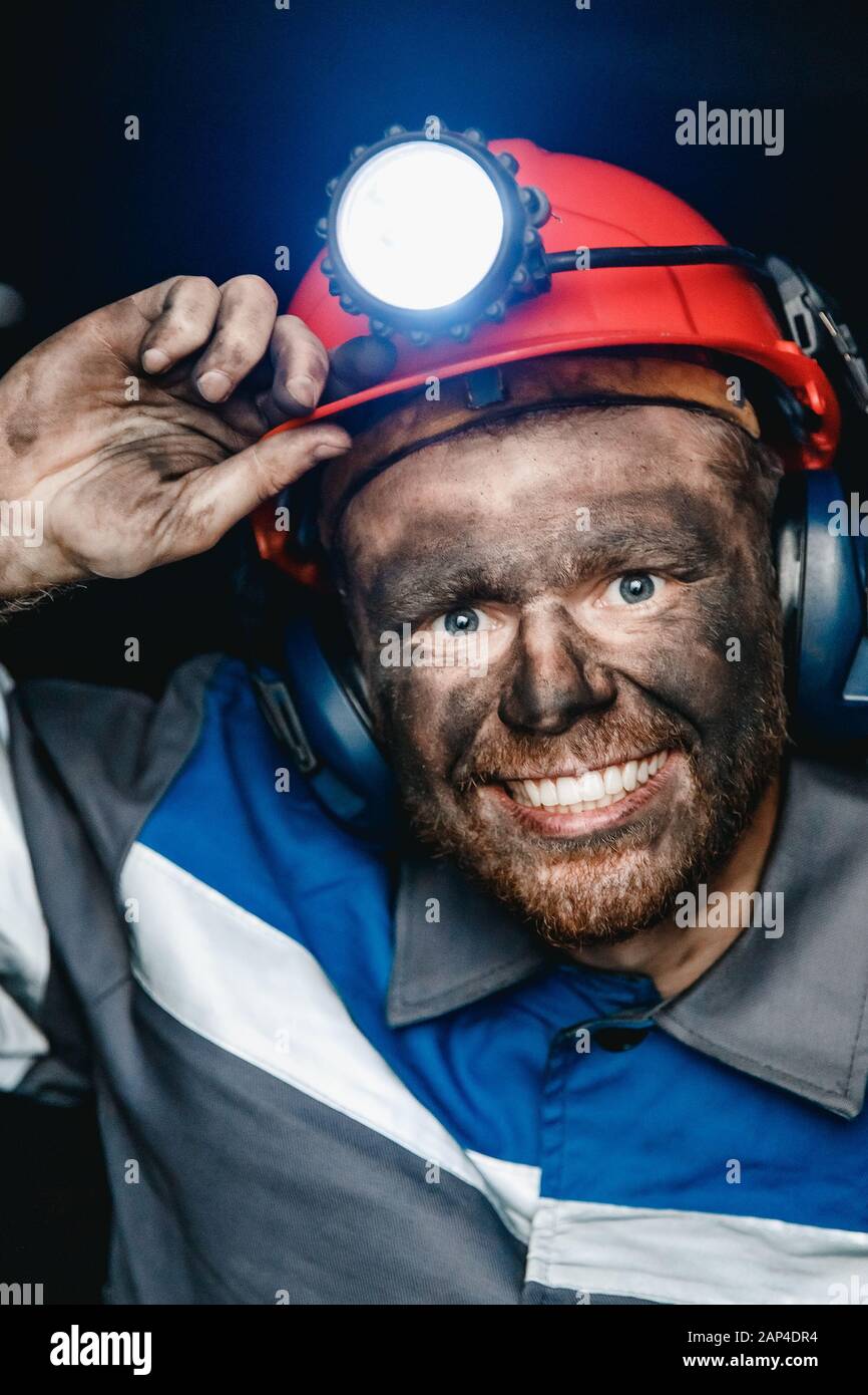 Portrait miner coal man in helmet with lantern in underground mine ...
