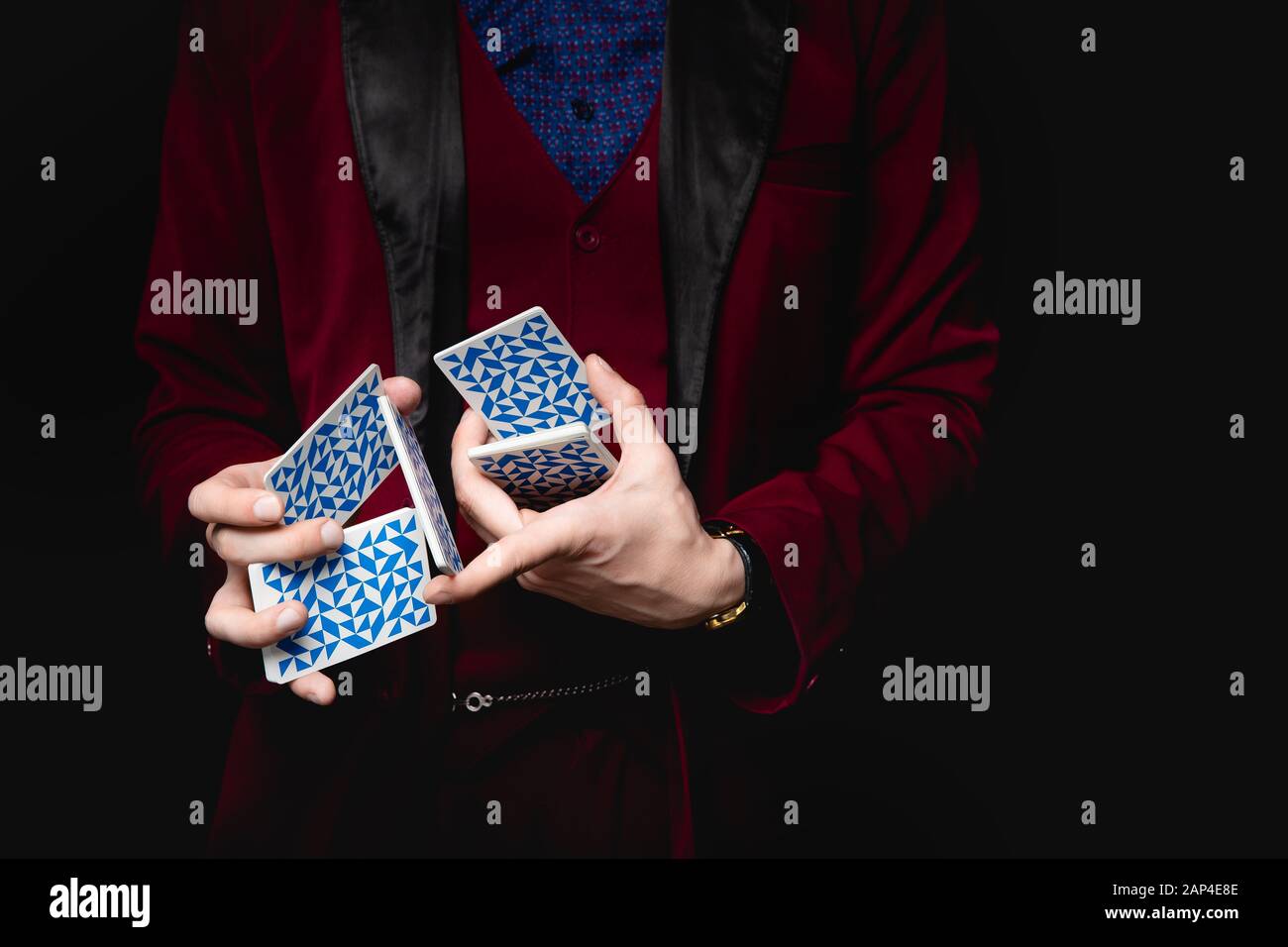 Magician shows trick with playing cards, dark background Stock Photo ...