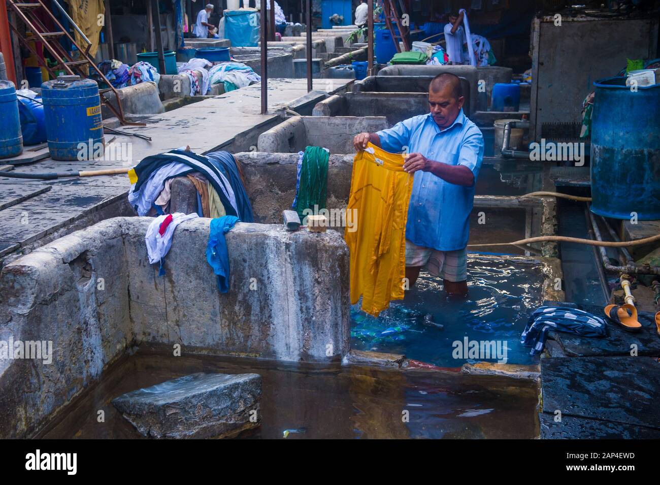 MUMBAI , INDIA - AUG 26 : Indian man work at Dhobi Ghat in Mumbai India ...