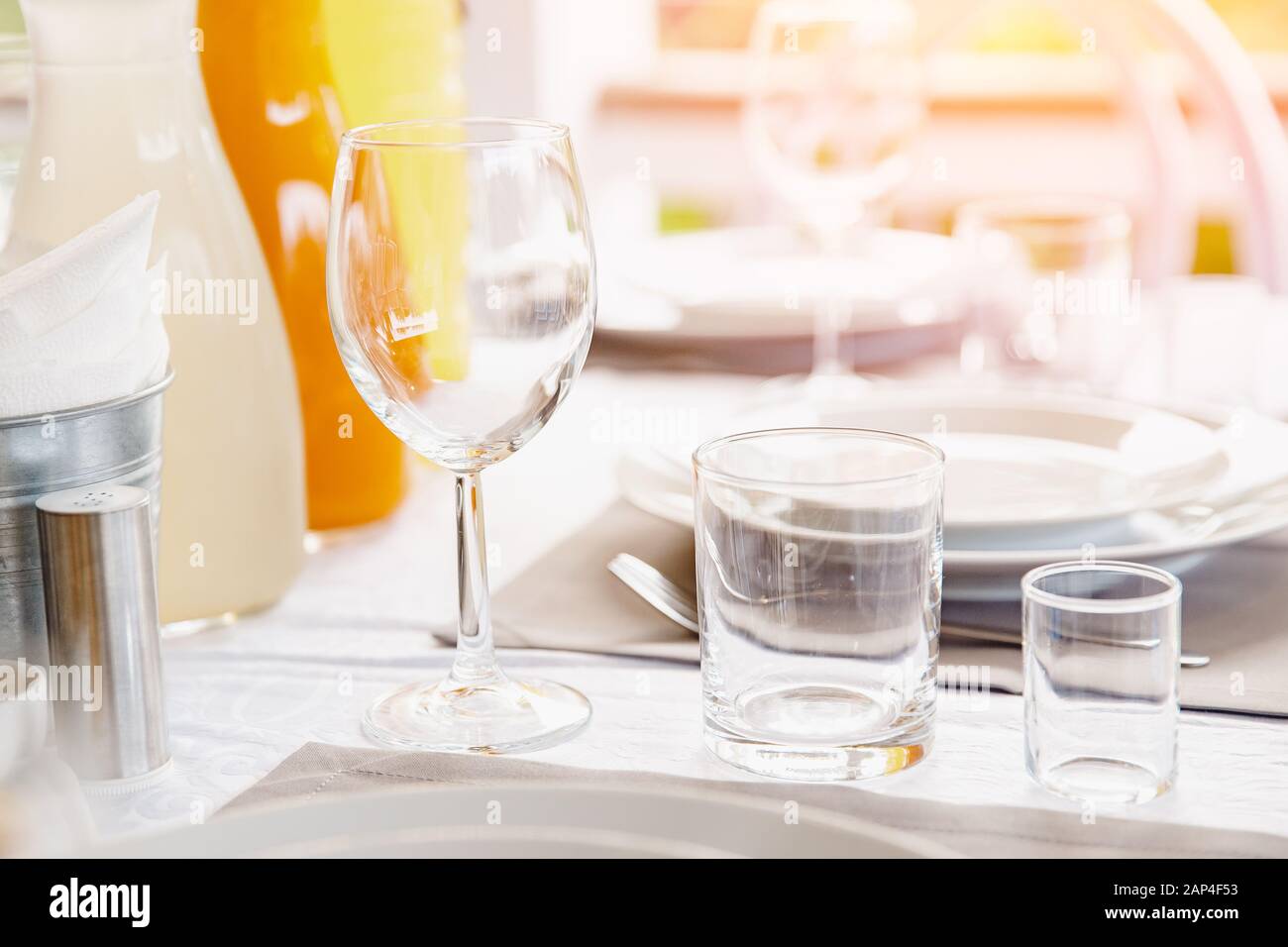 Catering service. Table setting, glass goblets, cutlery Stock Photo - Alamy