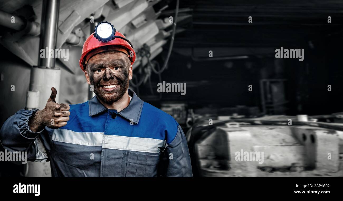 Portrait working young male miner in red cap showing thumbs up ...