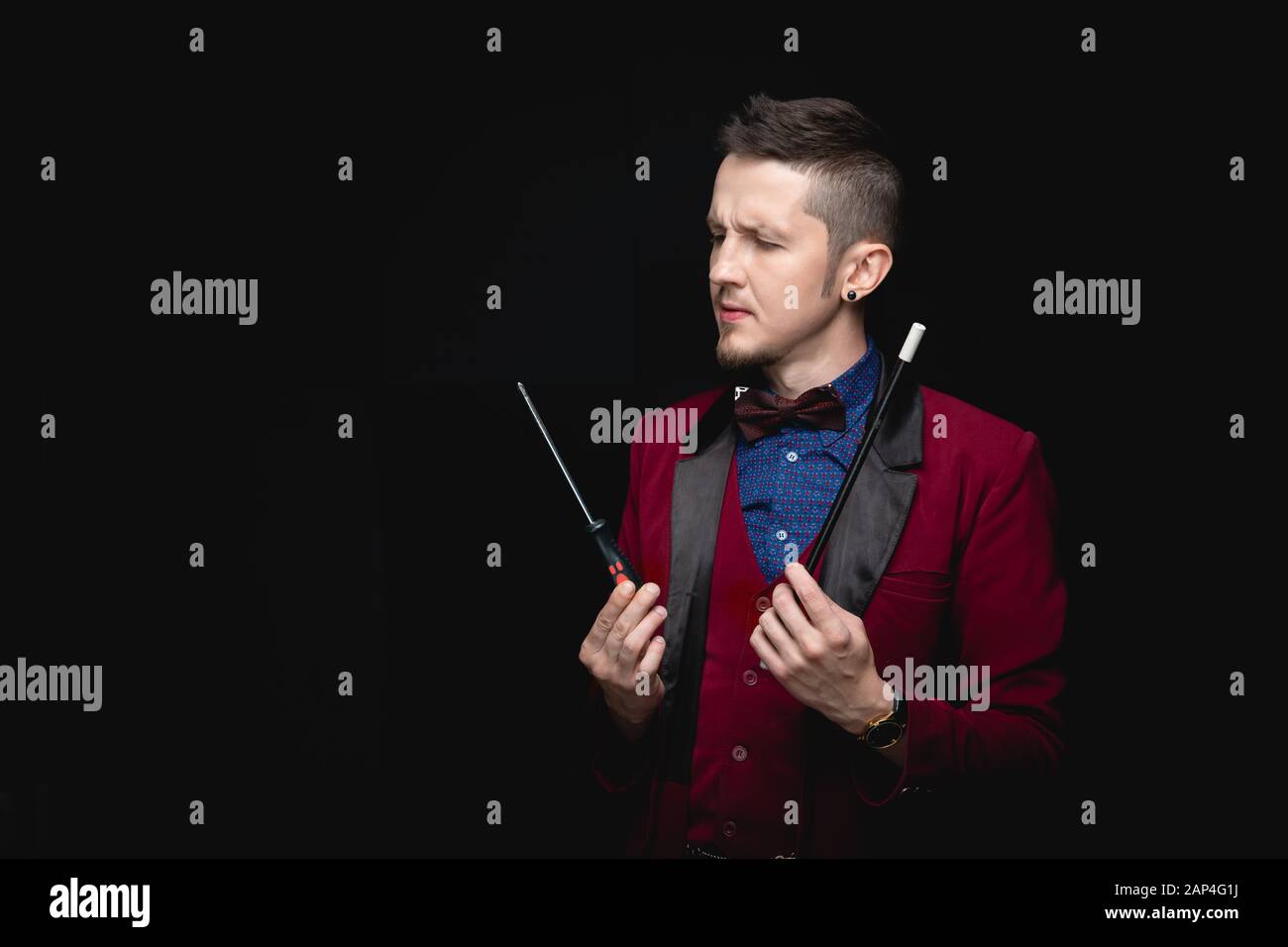 Male magician is experimenting with magic wands using screwdriver tool ...