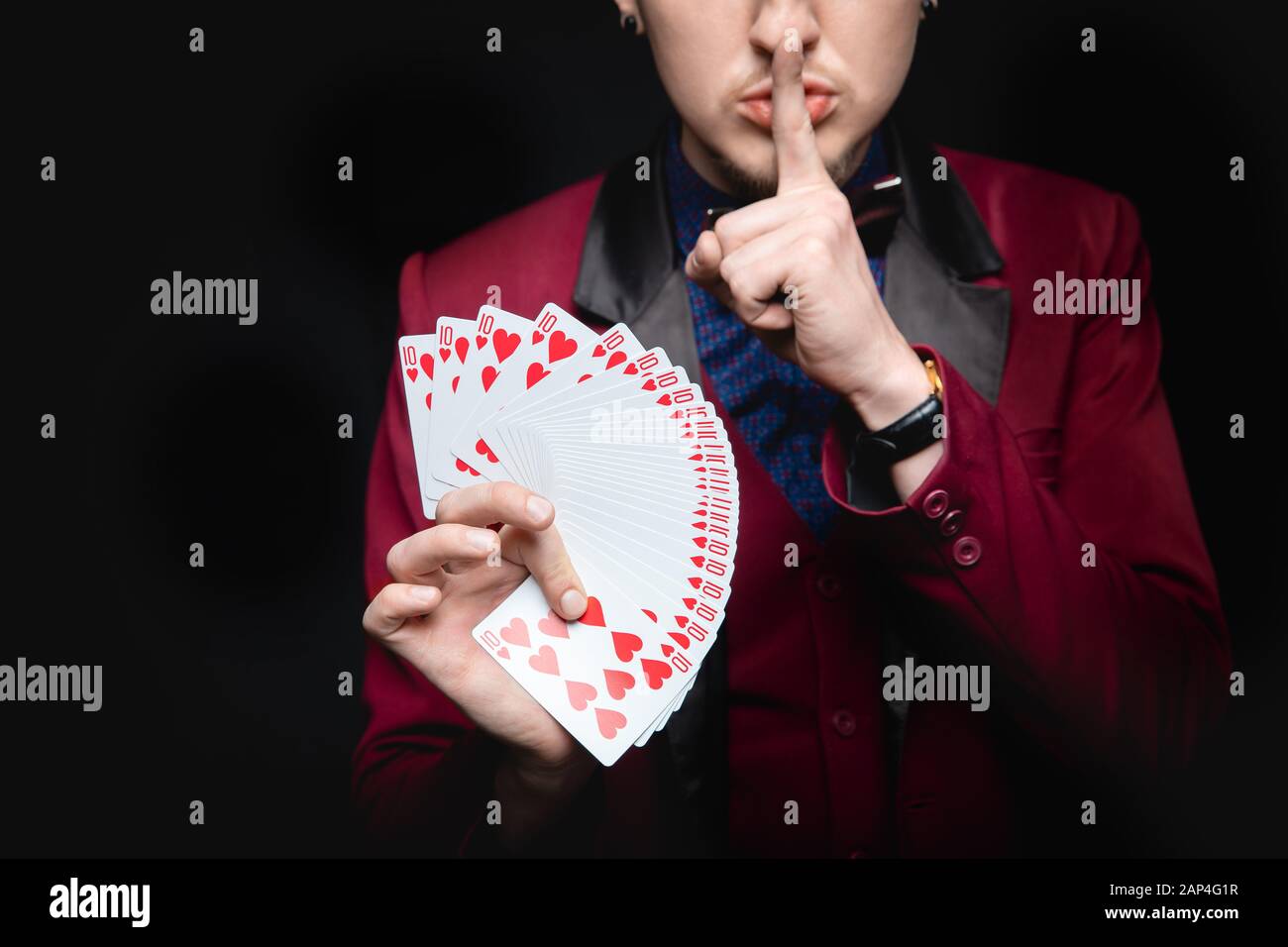 Disclosure of focus. Magician shows trick with playing same cards on ...
