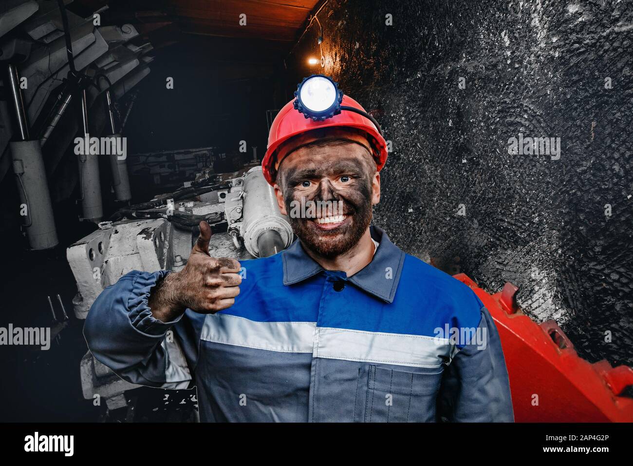 Portrait working young male miner in red cap showing thumbs up ...