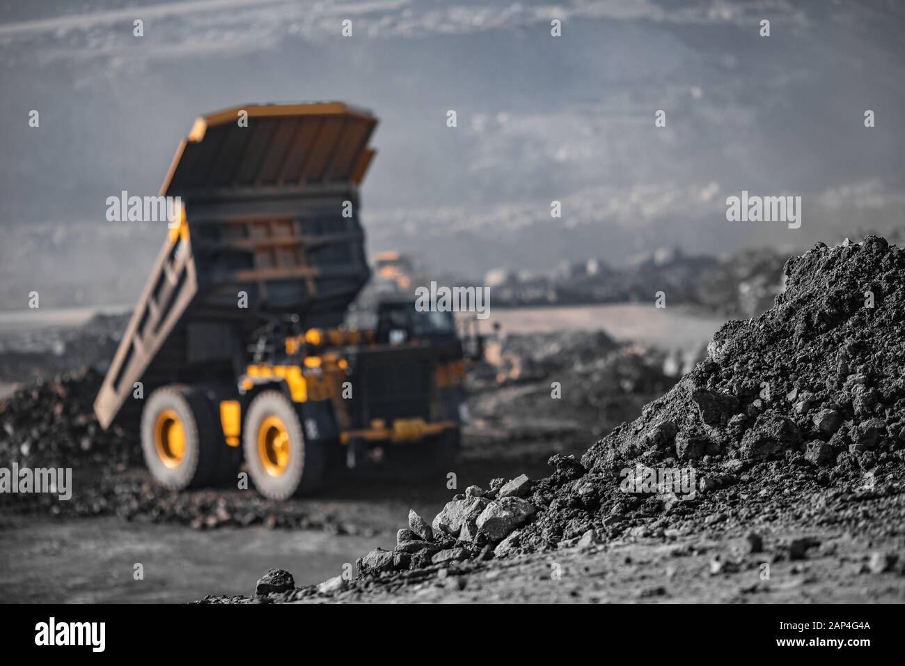 Close-up coal anthracite storage, in background large mining dump truck ...