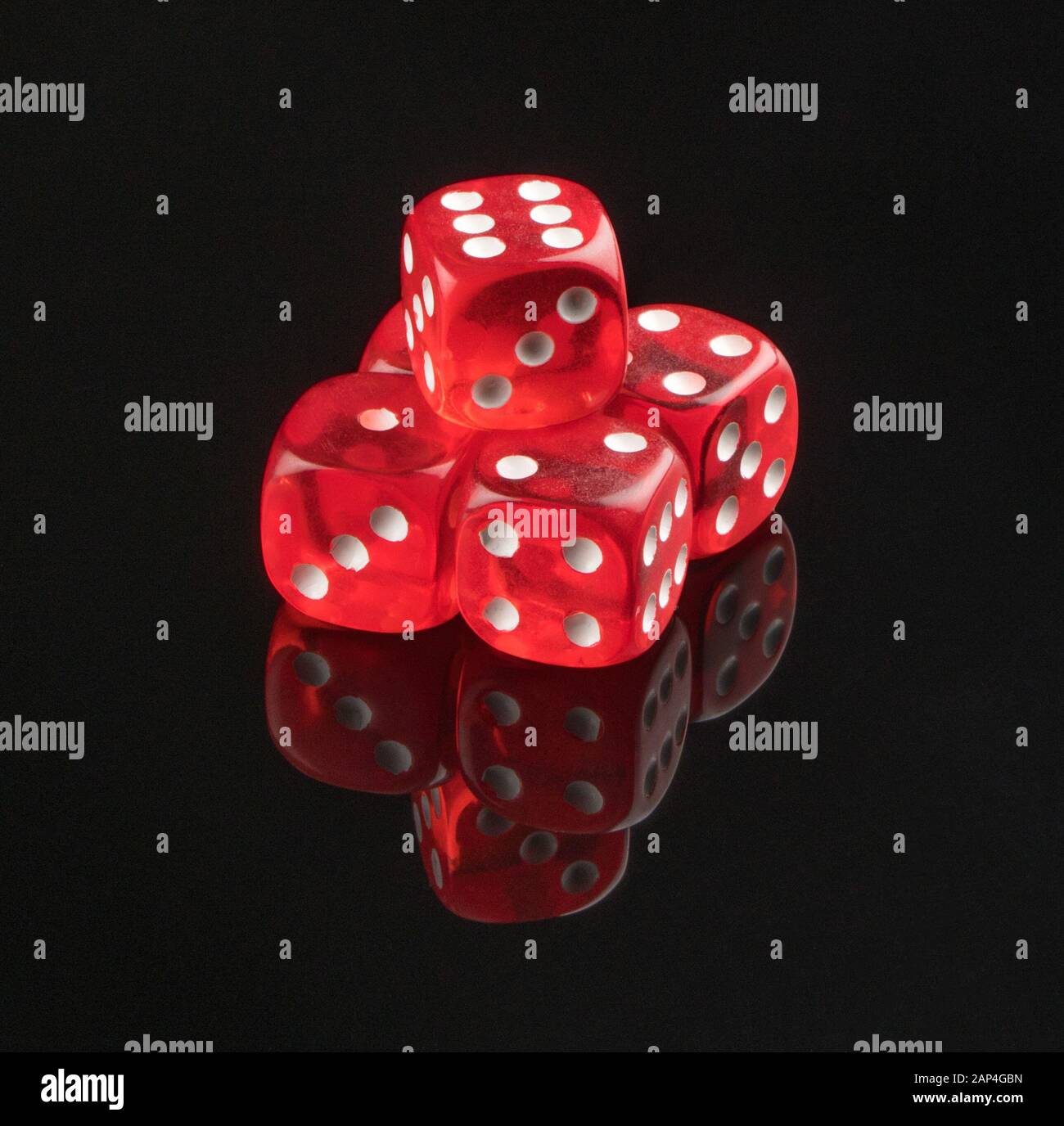 group of red playing dice on a black background with reflection ...
