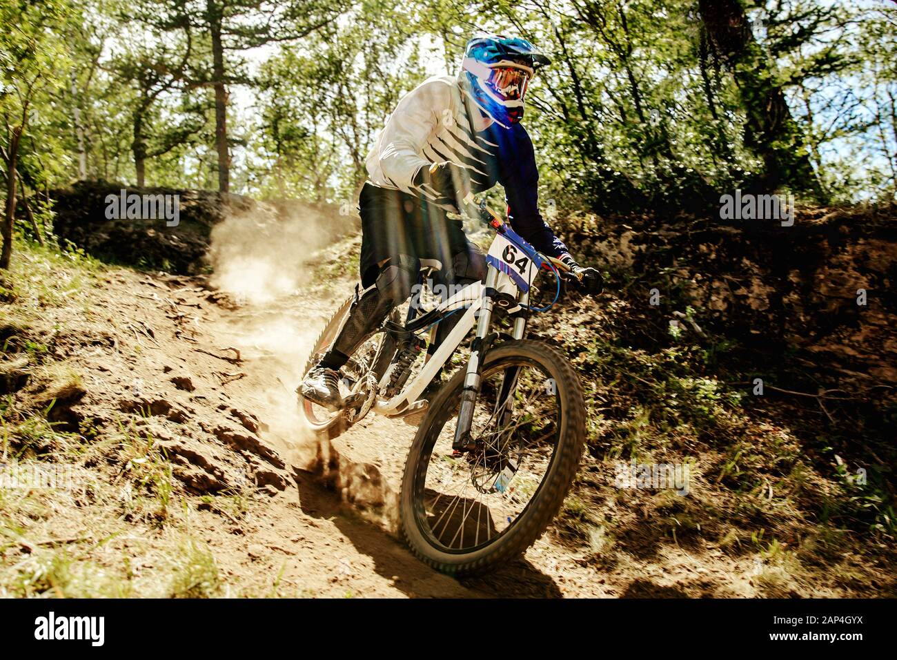 downhill xtreme trail rider riding race in sunlight Stock Photo - Alamy