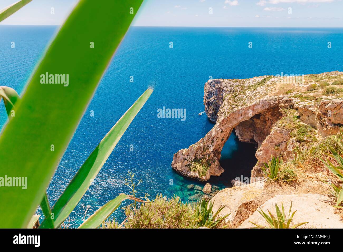 Blue Grotto in Malta. Pleasure boat with tourists runs. Natural arch ...