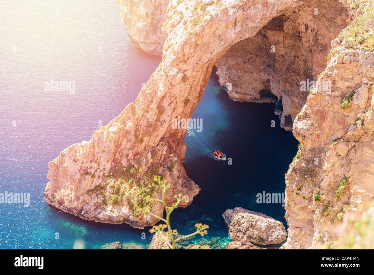 Blue Grotto in Malta. Pleasure boat with tourists runs. Natural arch ...