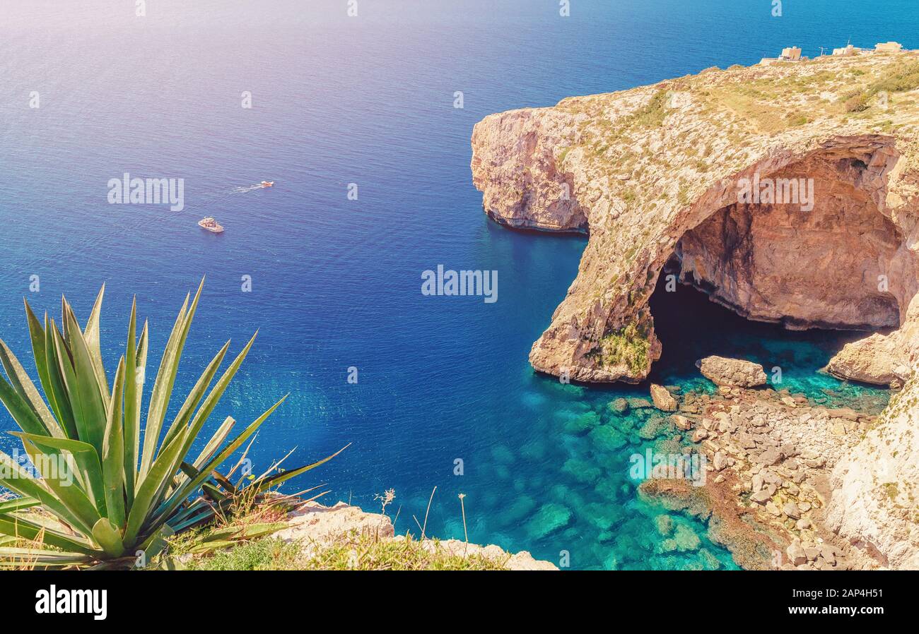Blue Grotto in Malta. Pleasure boat with tourists runs. Natural arch ...