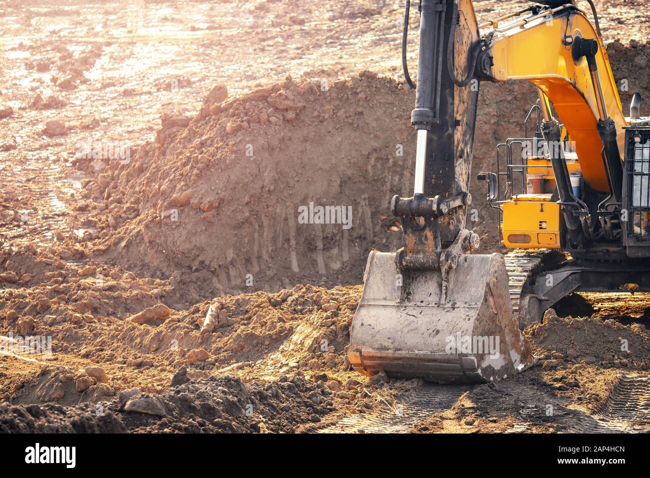 Loader excavator during earthmoving works removes overburden of soil ...