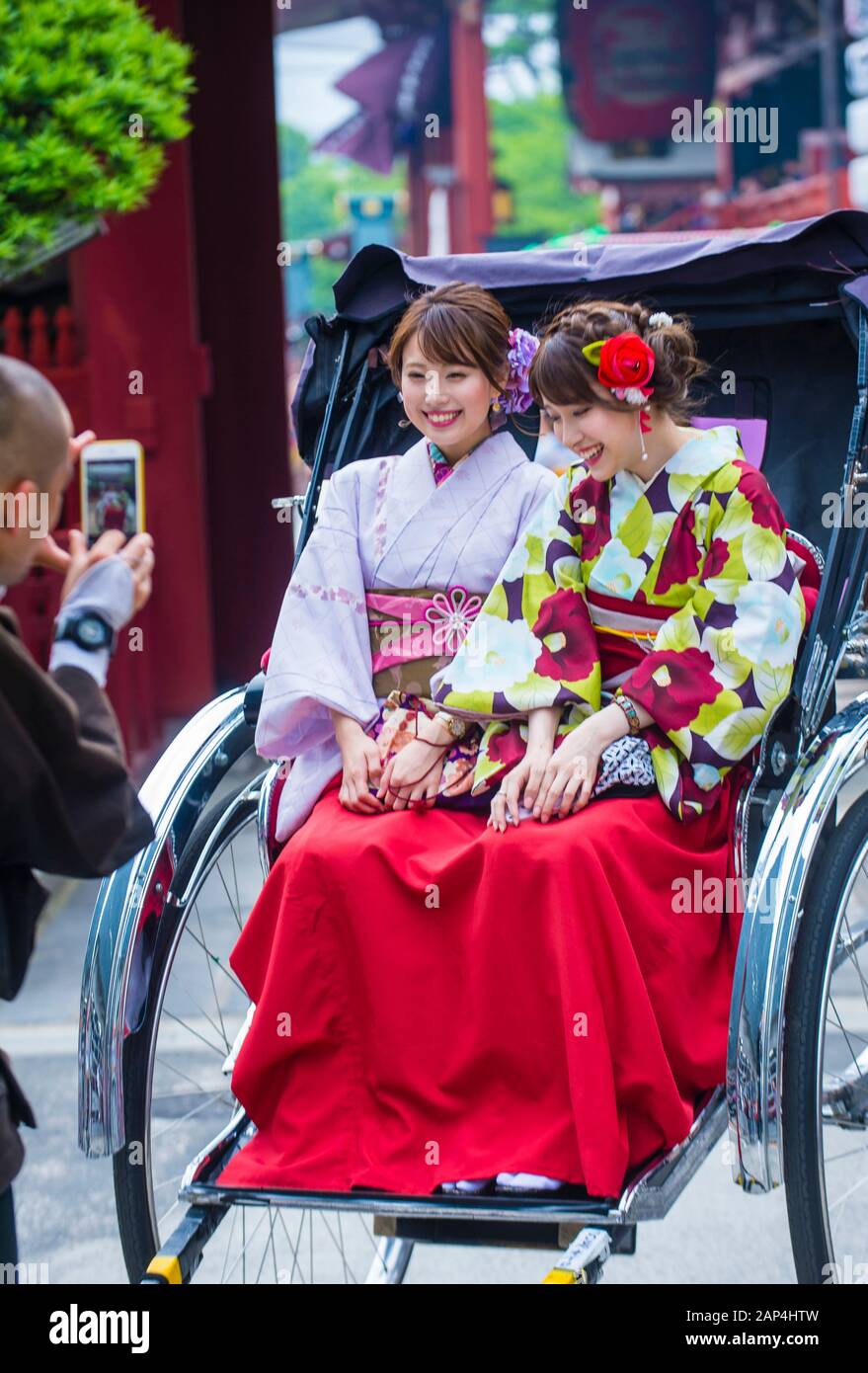 Japanese women with traditional Kimono riding Rickshaw in Tokyo Japan ...
