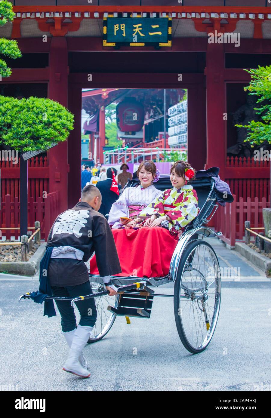 Japanese women with traditional Kimono riding Rickshaw in Tokyo Japan ...