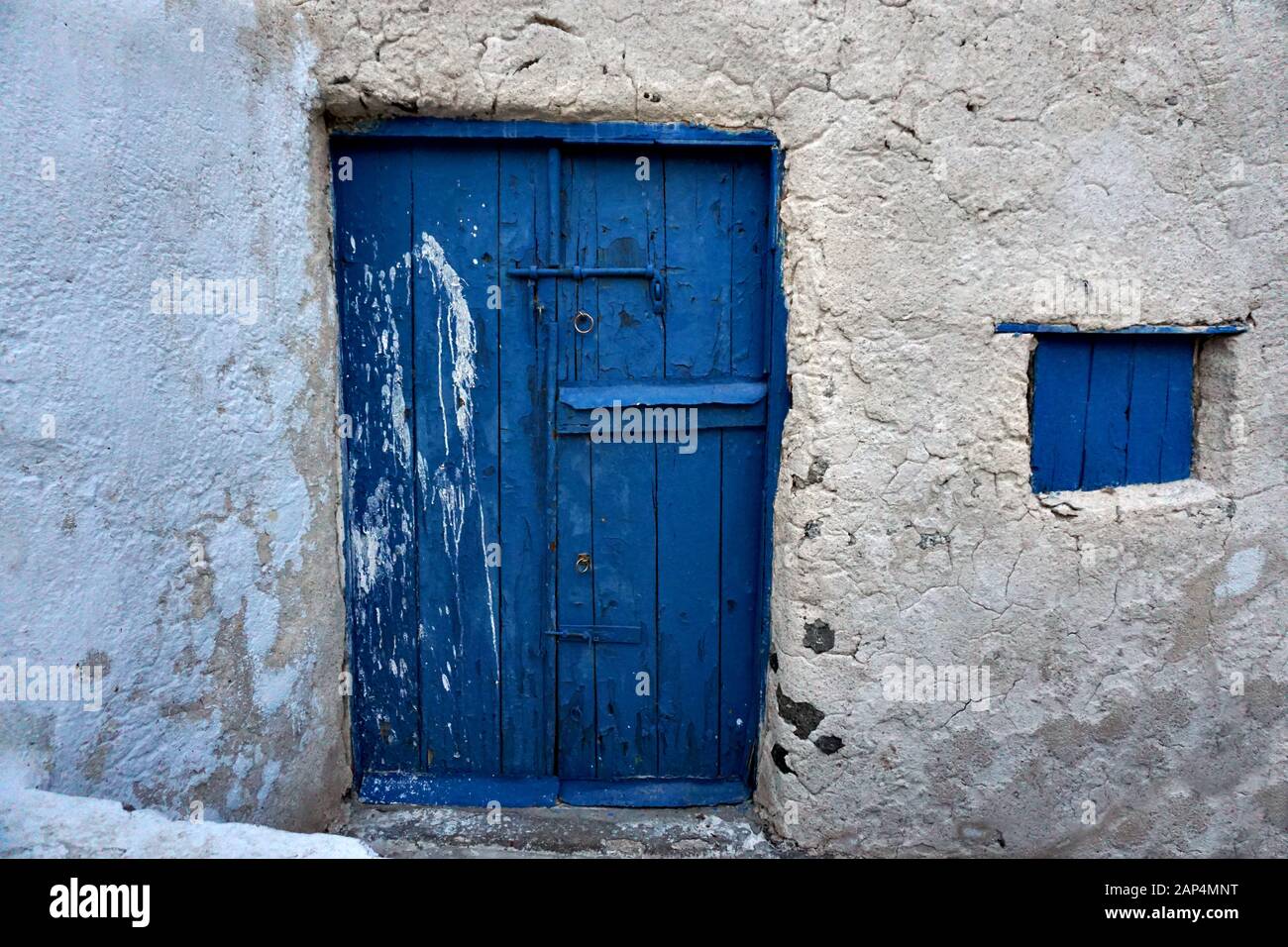 Old vintage blue wooden door with rustic stone wall Stock Photo - Alamy