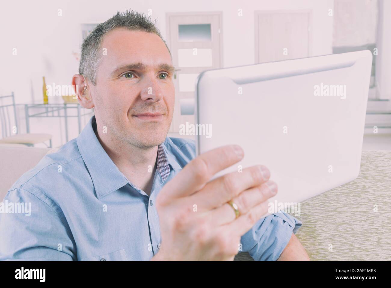 Smiling Deaf man talking using sign language on the tablets's cam Stock ...