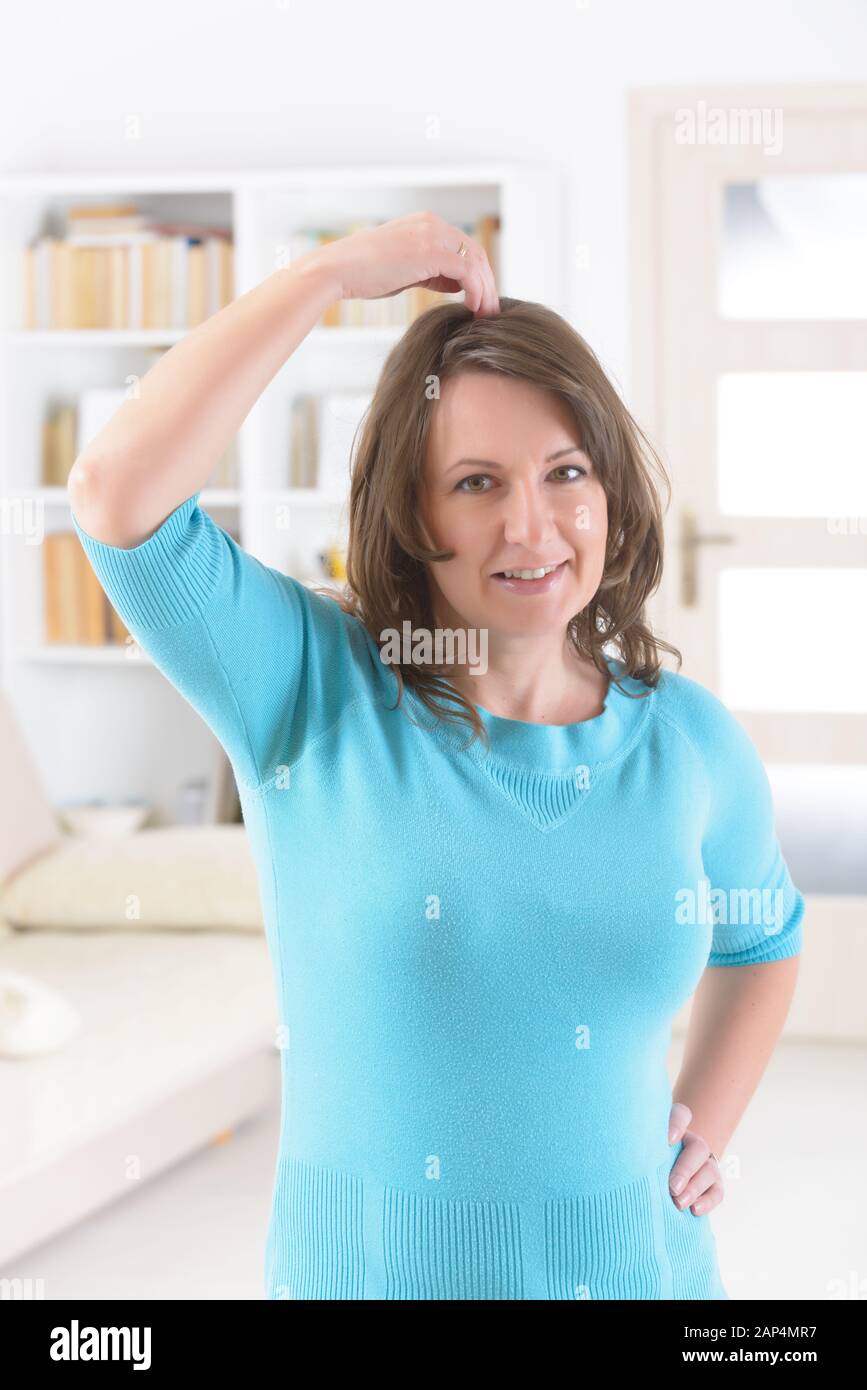 Woman doing EFT on the top head point. Emotional Freedom Techniques ...