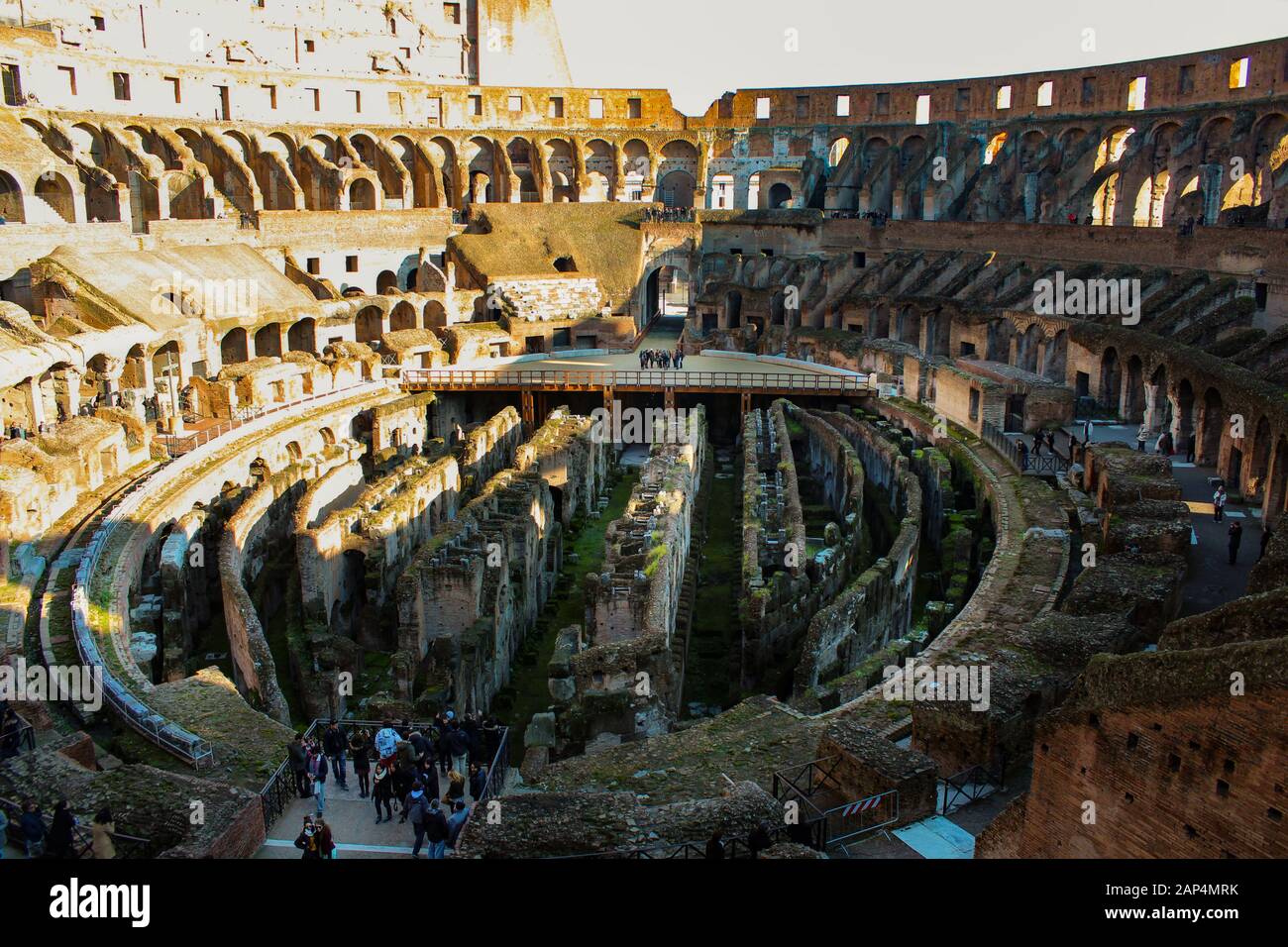 The Colosseum in Rome with tourists. The structure's ruins lie on the ...