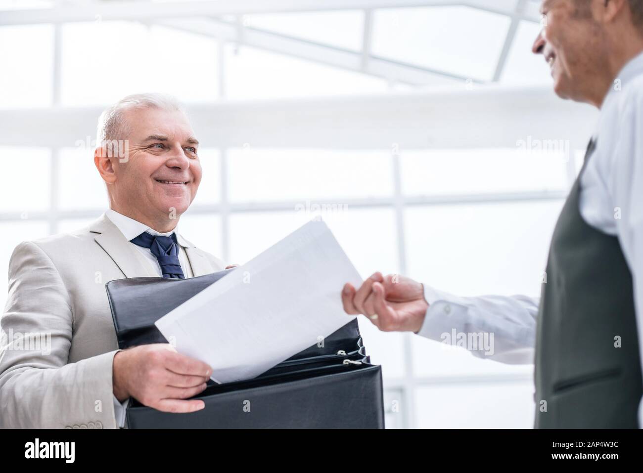 close up. businessman receiving document from Bank employee Stock Photo ...