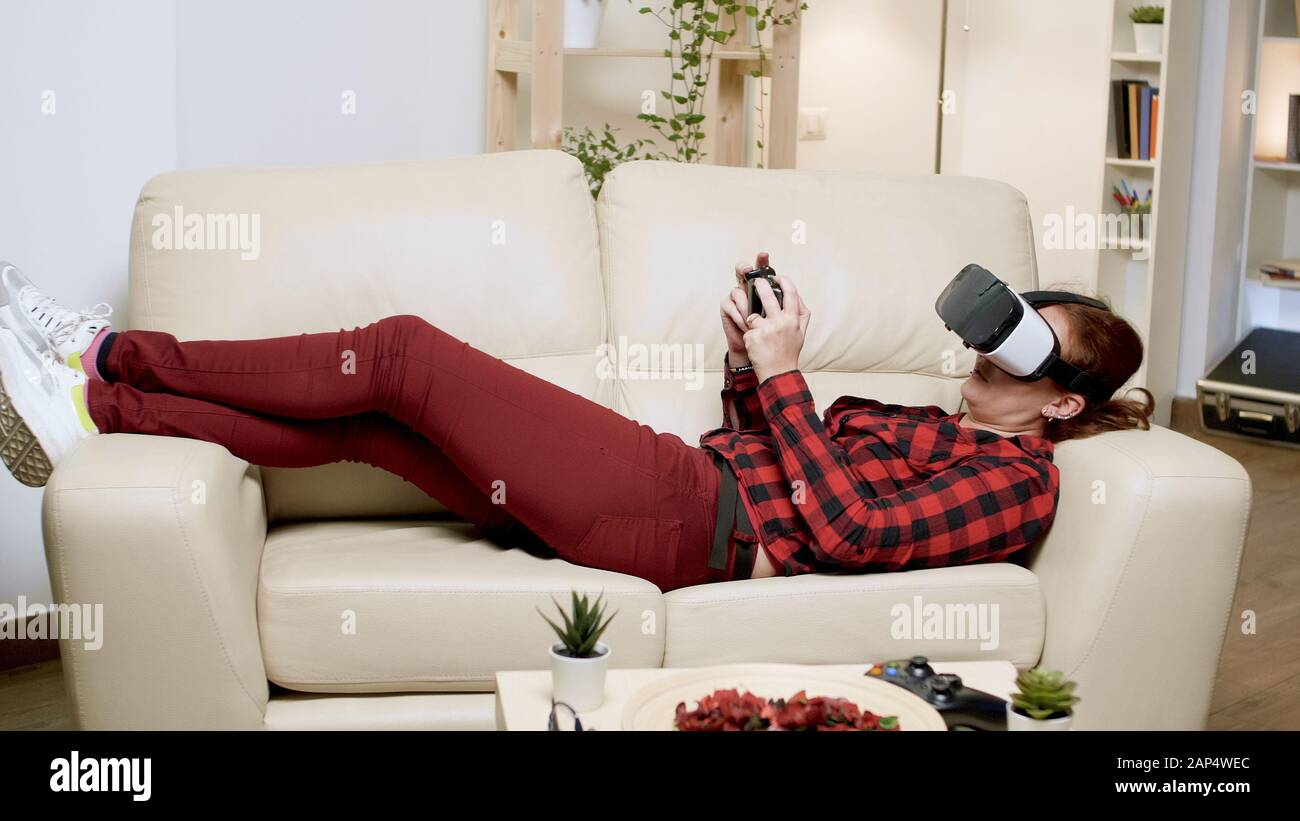 Young woman using modern technology for playing video games. Female ... Young woman using modern technology for playing video games. Female ...