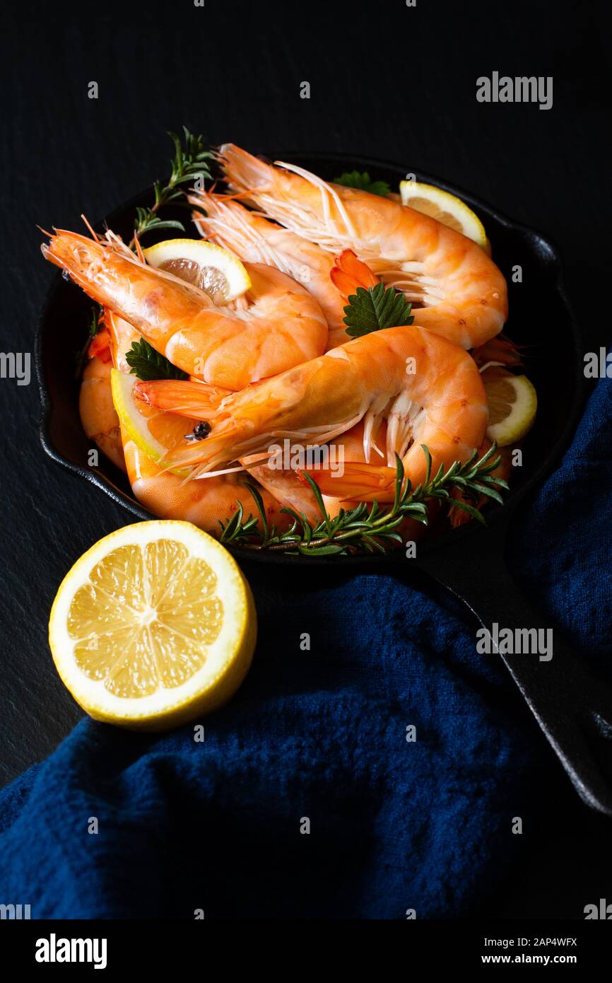 Seafood concept Ocean king prawns cooked in skillet iron cast on black ...